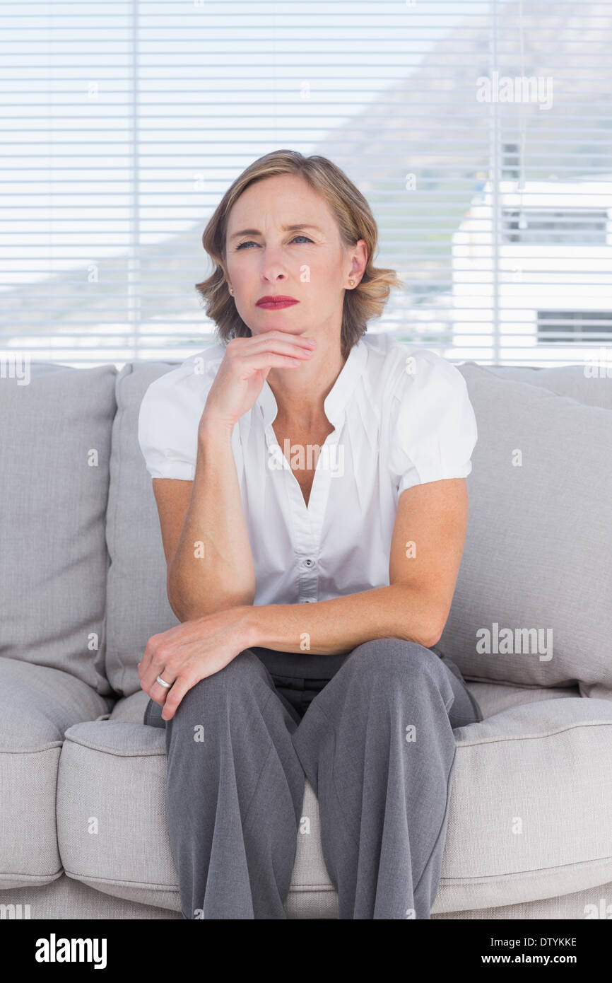 Businesswoman sitting on couch thinking hi-res stock photography and ...