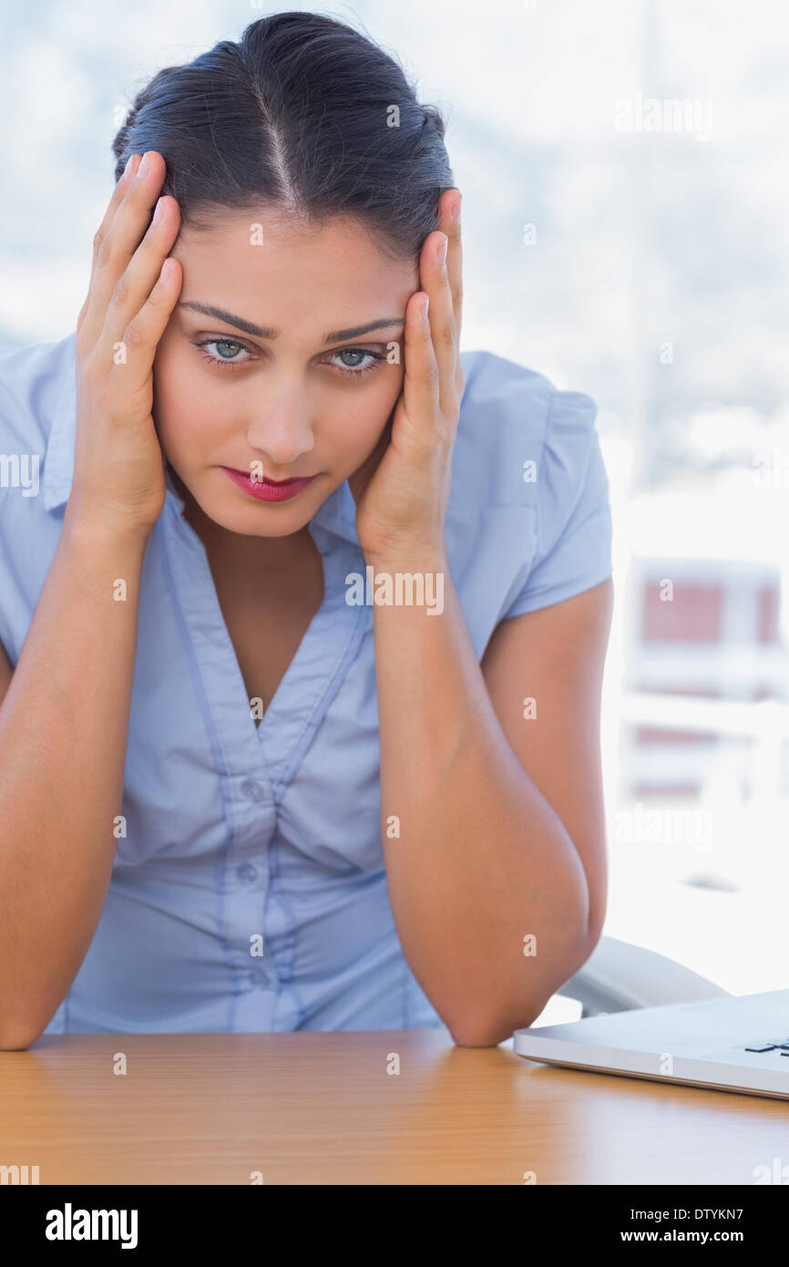 Sad businesswoman having her head in hands Stock Photo - Alamy