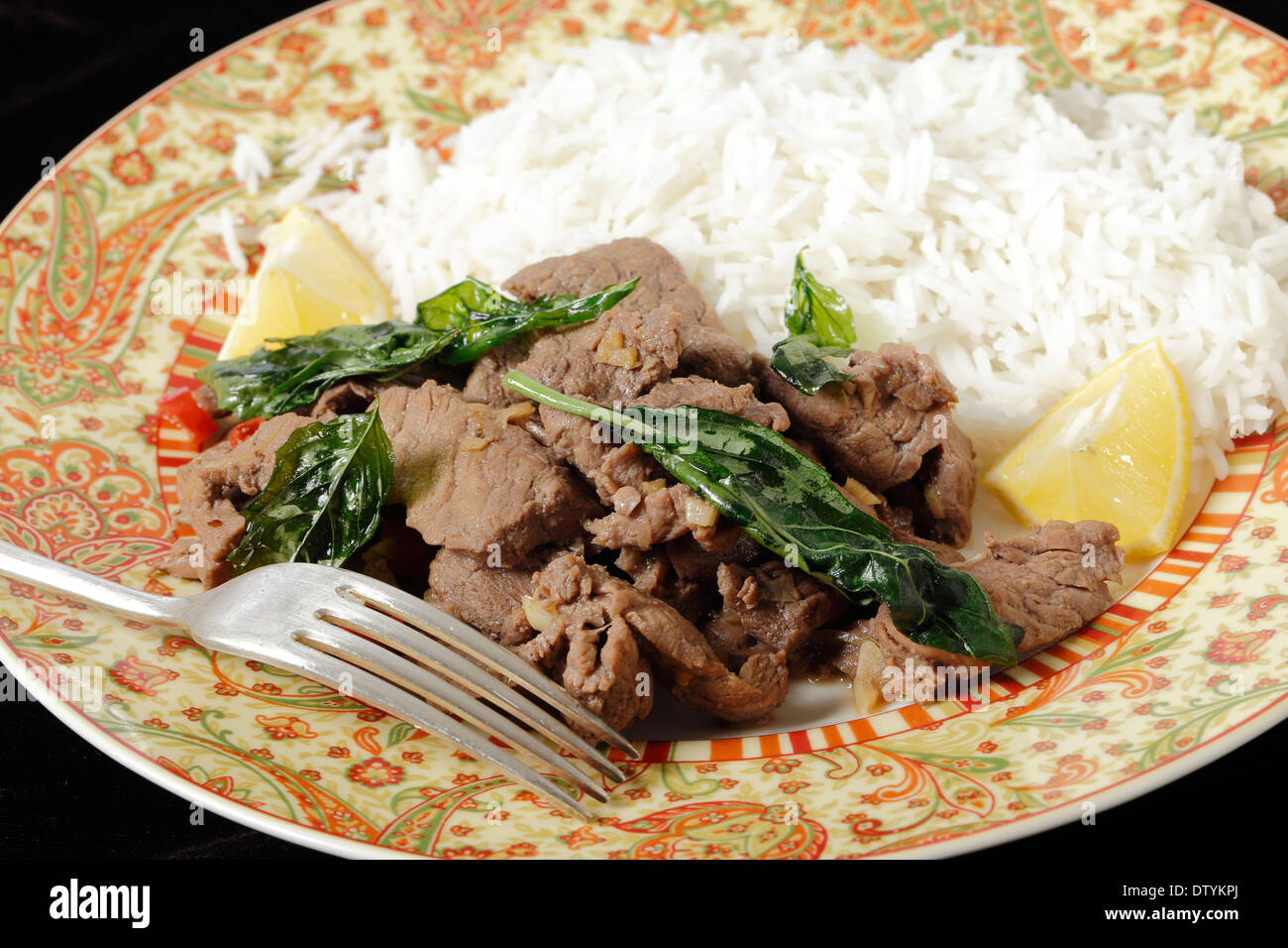 Chilli beef with crispy fried basil leaves, served with white basmati ...