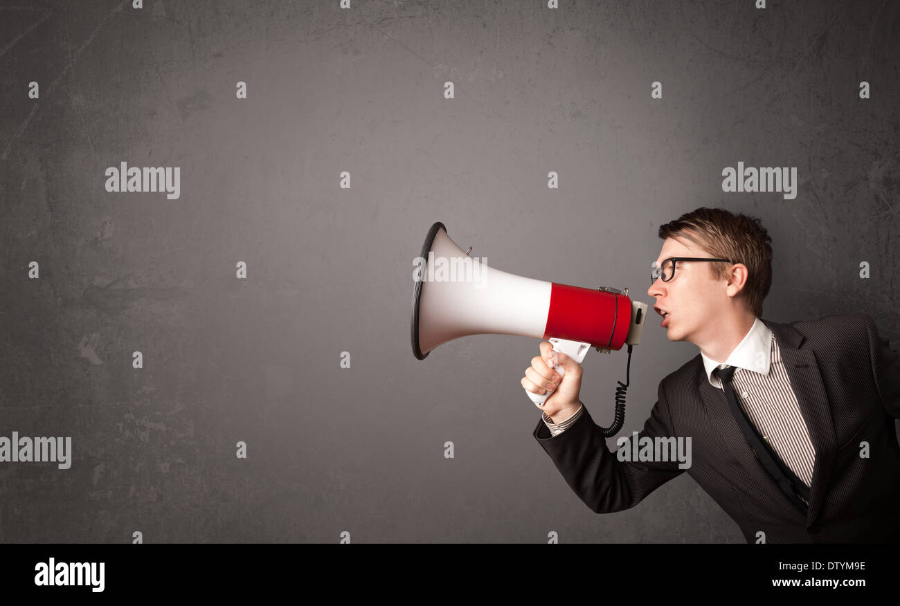 Guy shouting into megaphone on copy space background Stock Photo - Alamy
