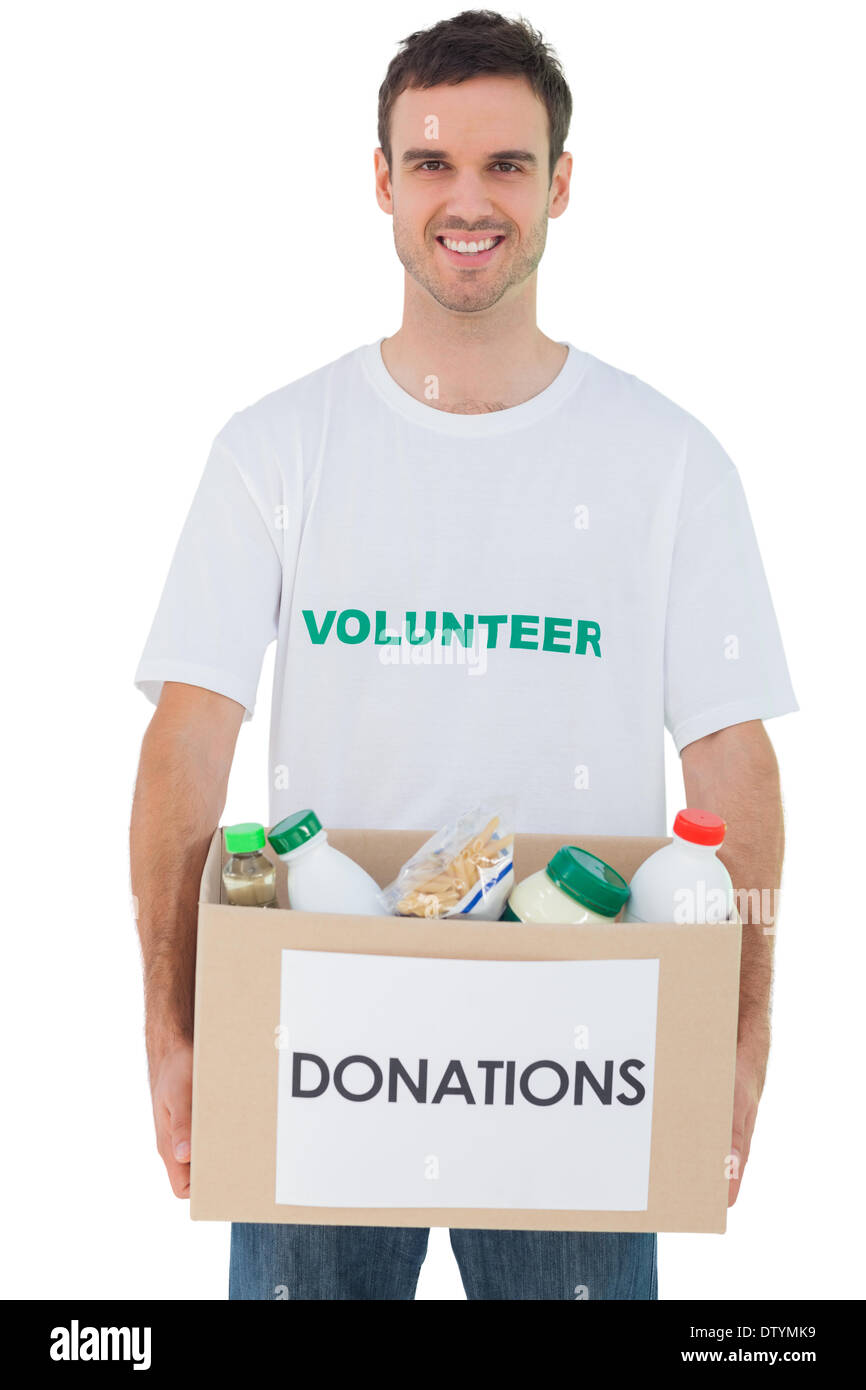 Handsome man carrying donation box with food Stock Photo - Alamy