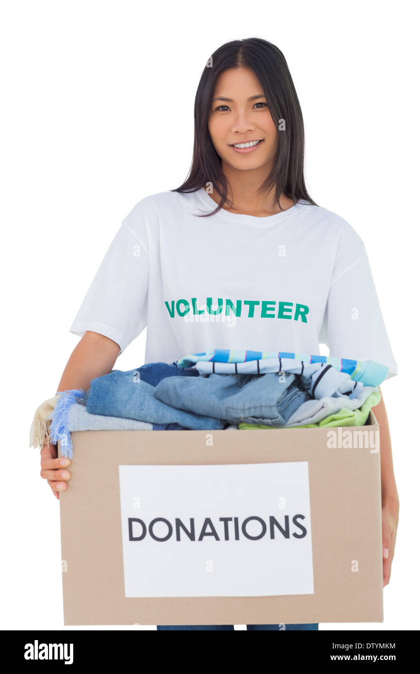 Happy woman carrying donation box Stock Photo - Alamy