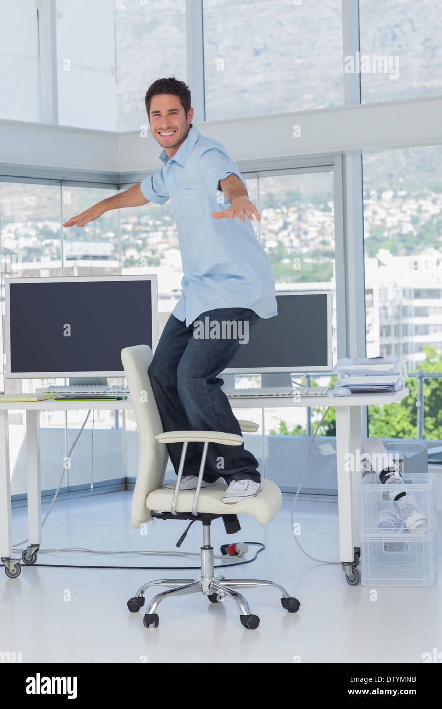 Creative designer surfing his swivel chair Stock Photo - Alamy