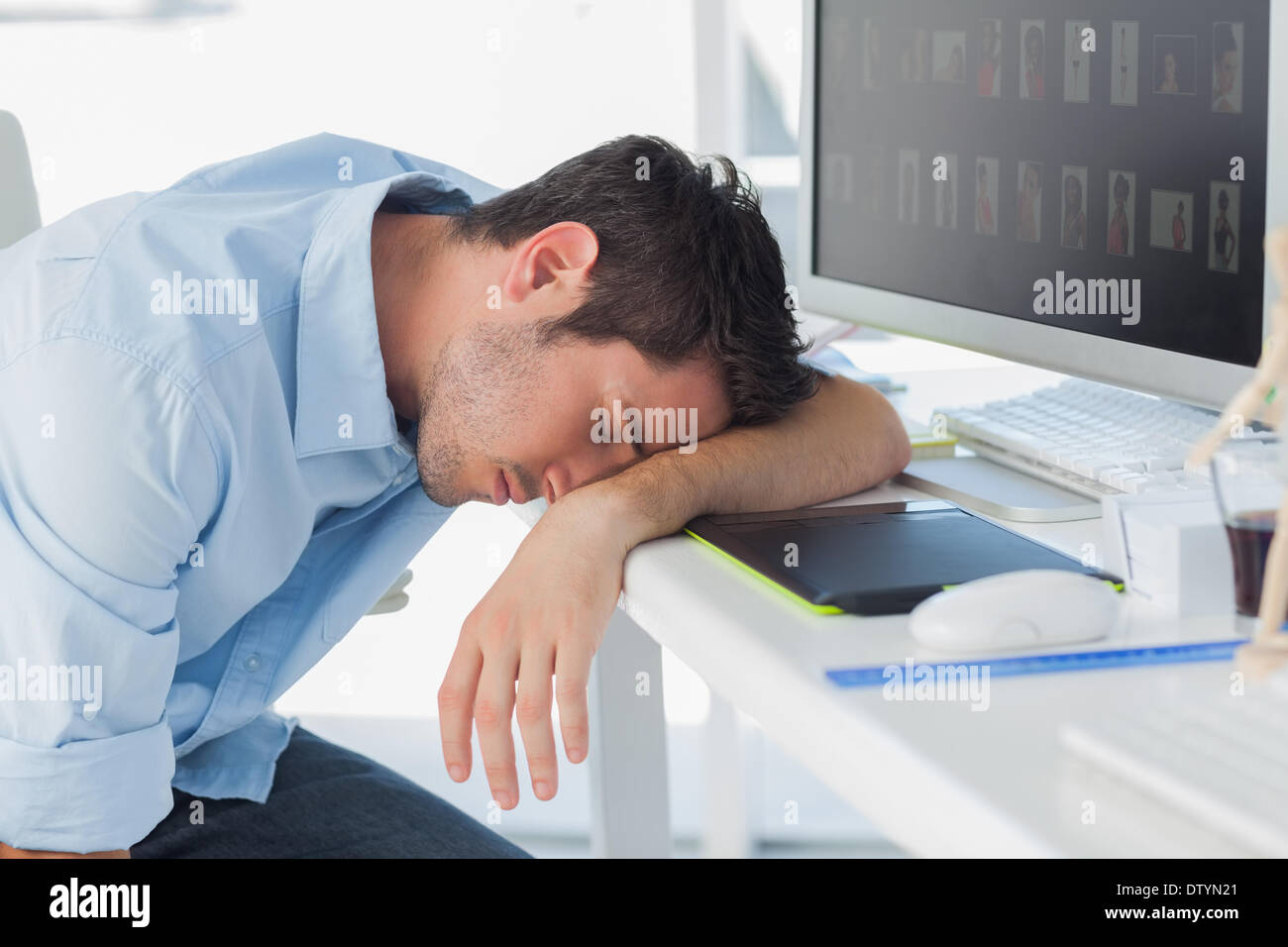 Graphic designer sleeping on the keyboard Stock Photo - Alamy