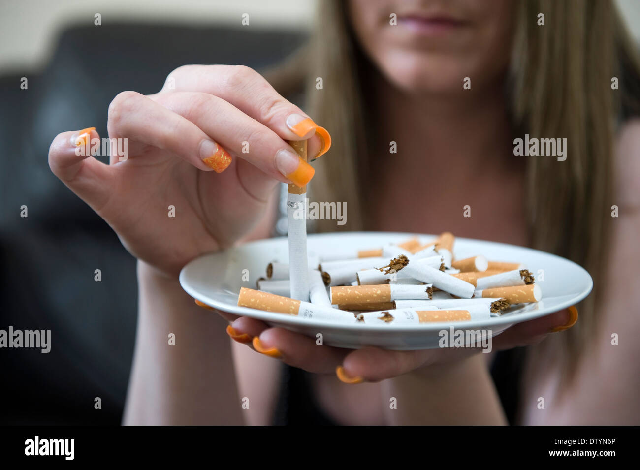 Woman stubs out cigarette hi-res stock photography and images - Alamy