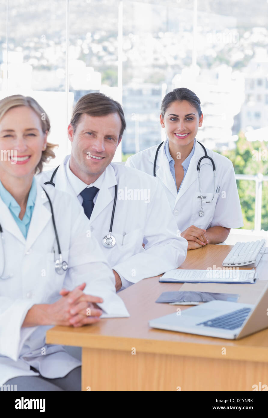 Cheerful mature doctor posing hi-res stock photography and images - Alamy