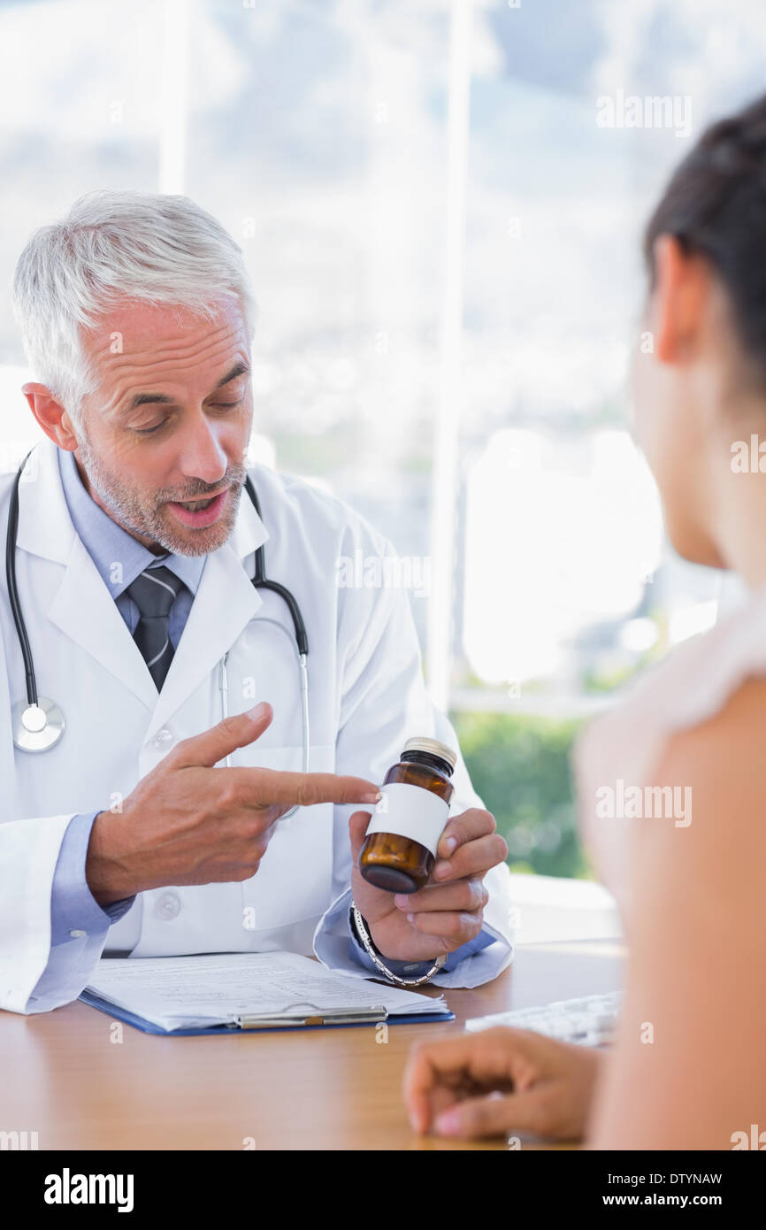Doctor showing bottle of pills to patient Stock Photo - Alamy