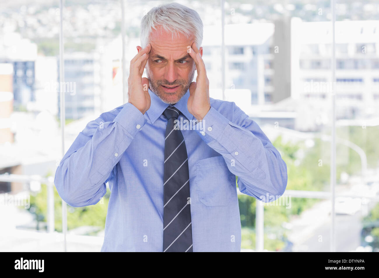 Mature man rubbing temples hi-res stock photography and images - Alamy