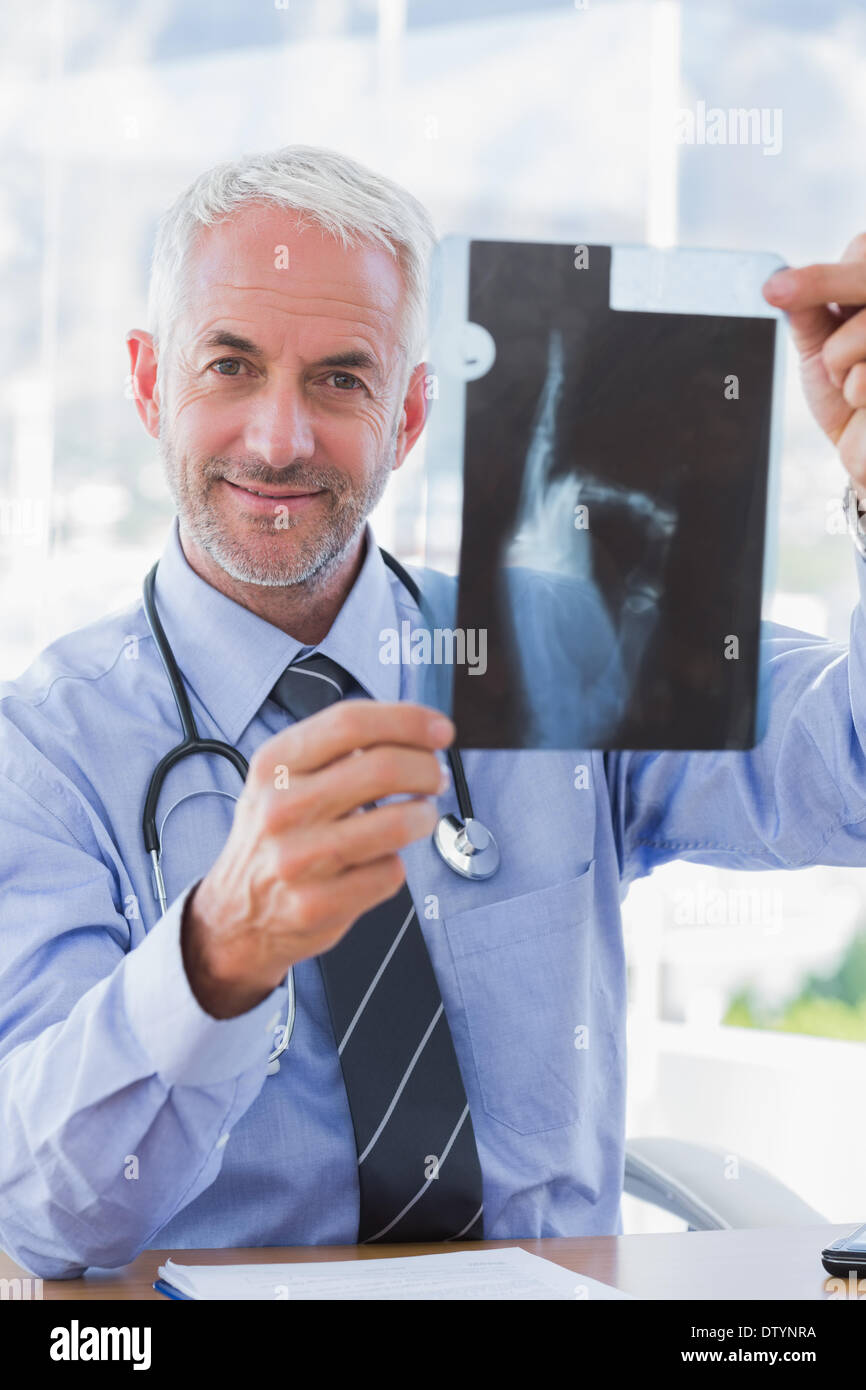 Attractive doctor showing radiography hi-res stock photography and ...