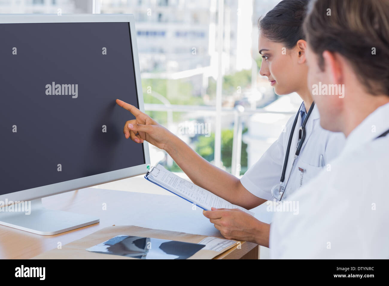 Doctor pointing at the screen of a computer Stock Photo - Alamy