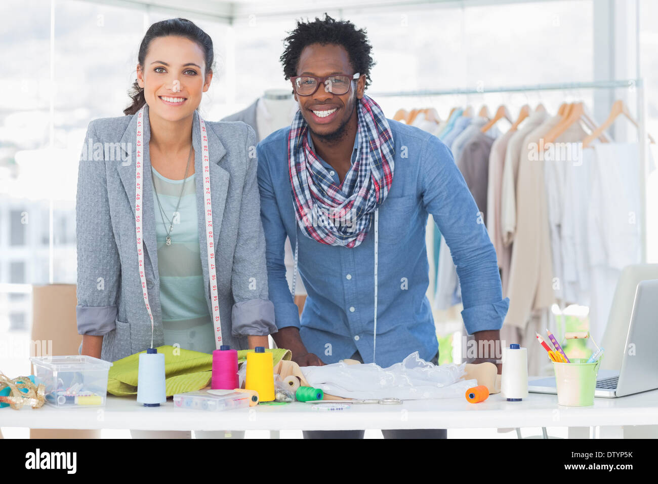 Two fashion designers smiling Stock Photo - Alamy