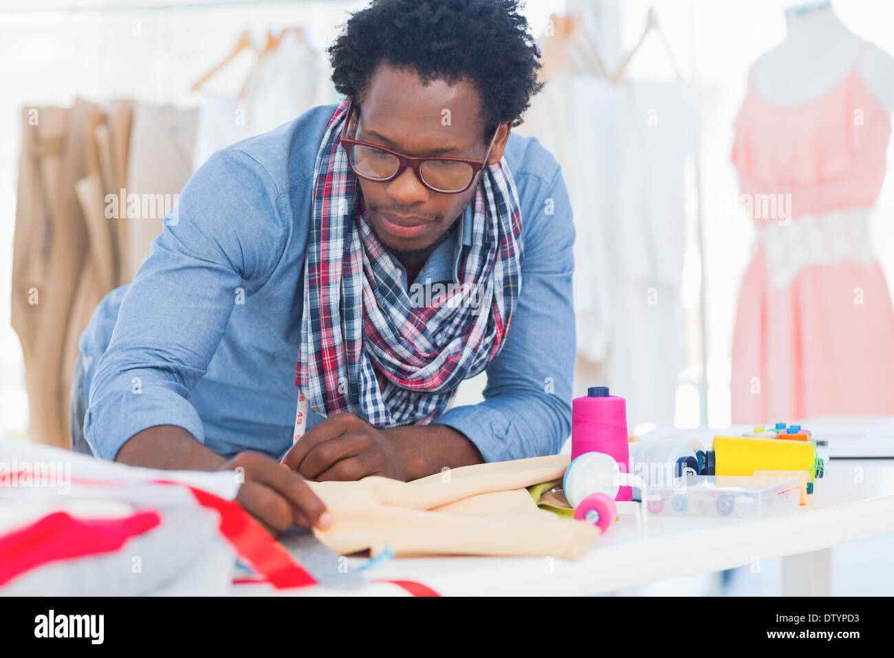 Creative designer measuring clothes Stock Photo - Alamy