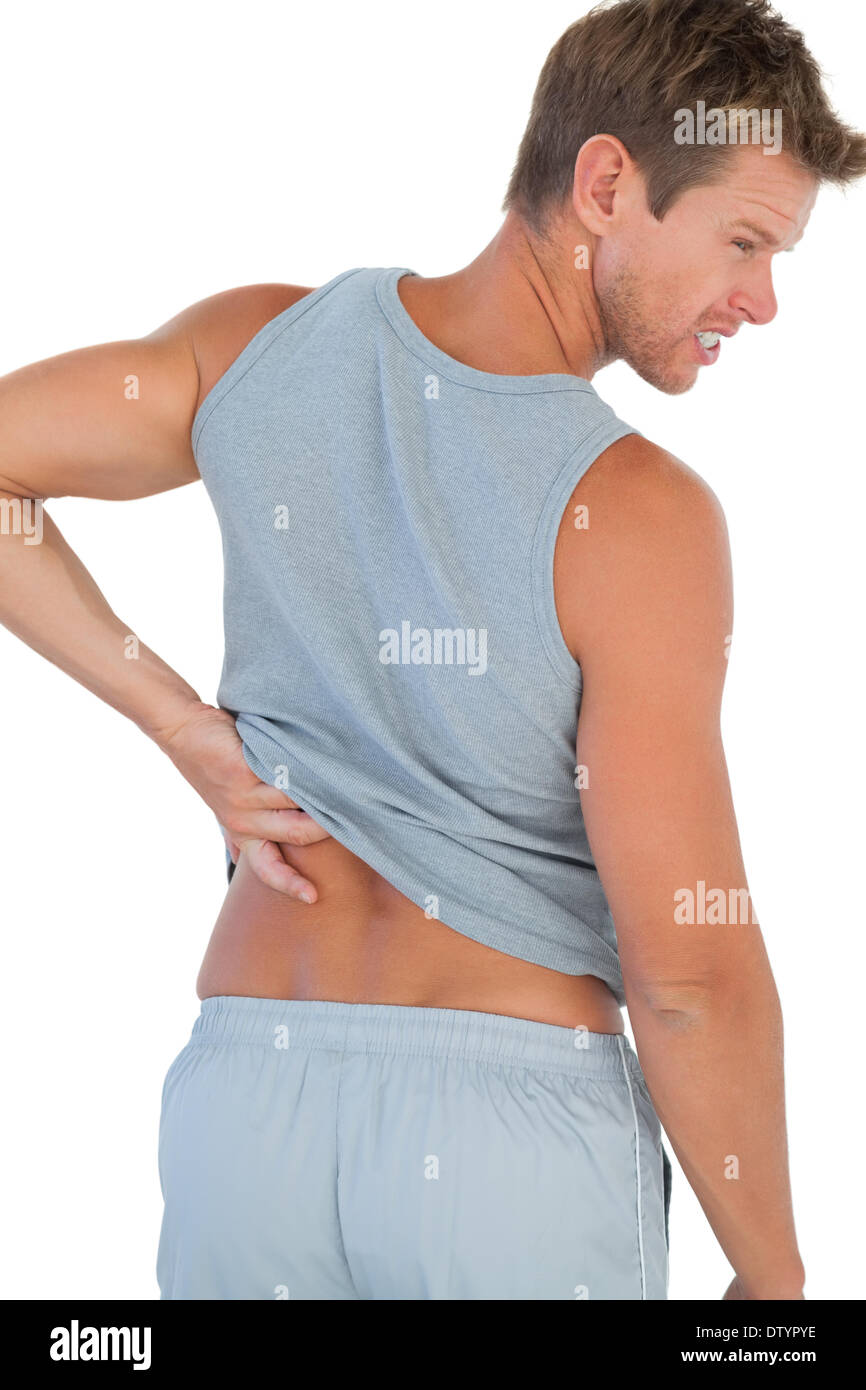 Man grimacing because of a back pain Stock Photo - Alamy