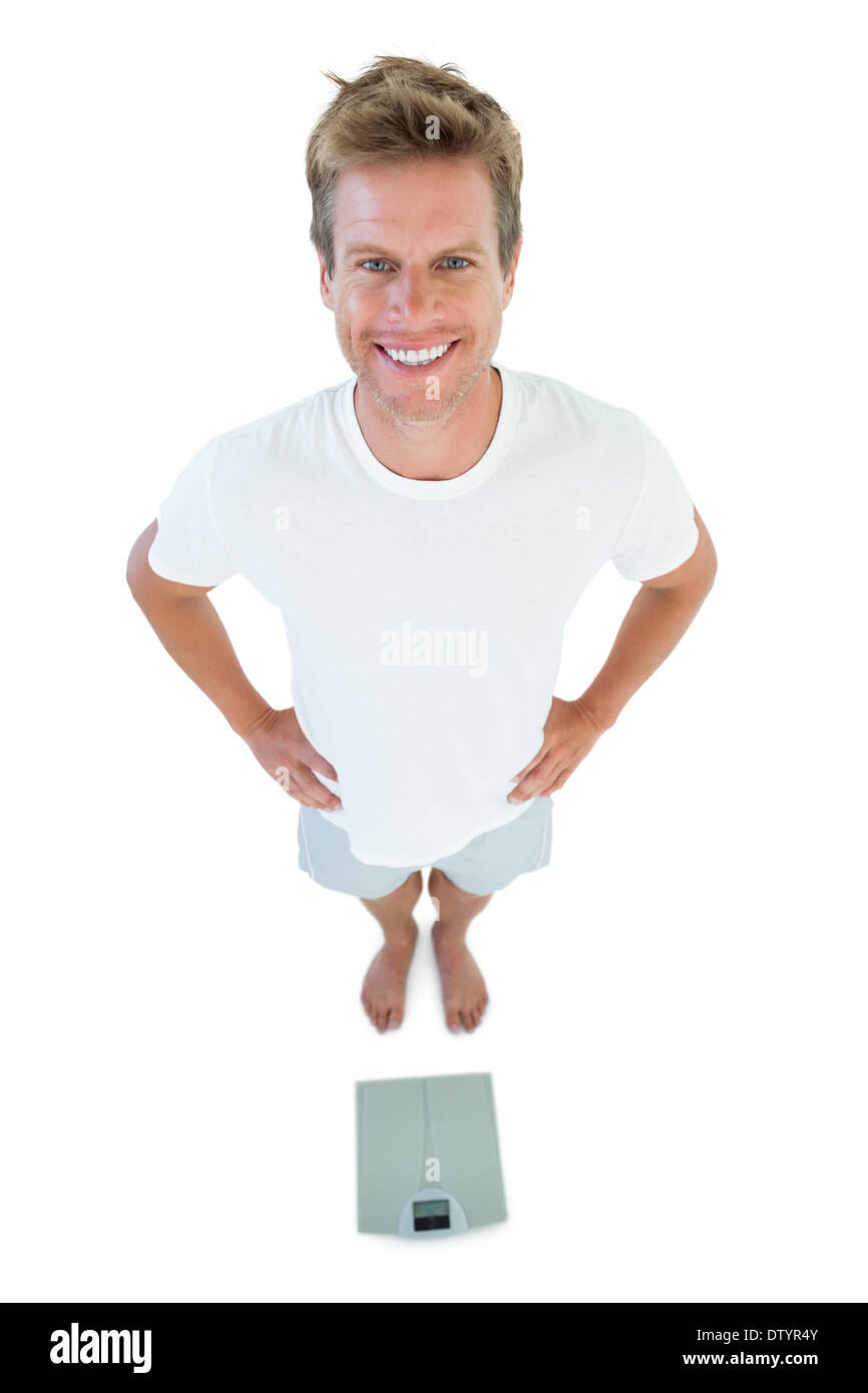 Man standing in front of weighing scale Stock Photo - Alamy