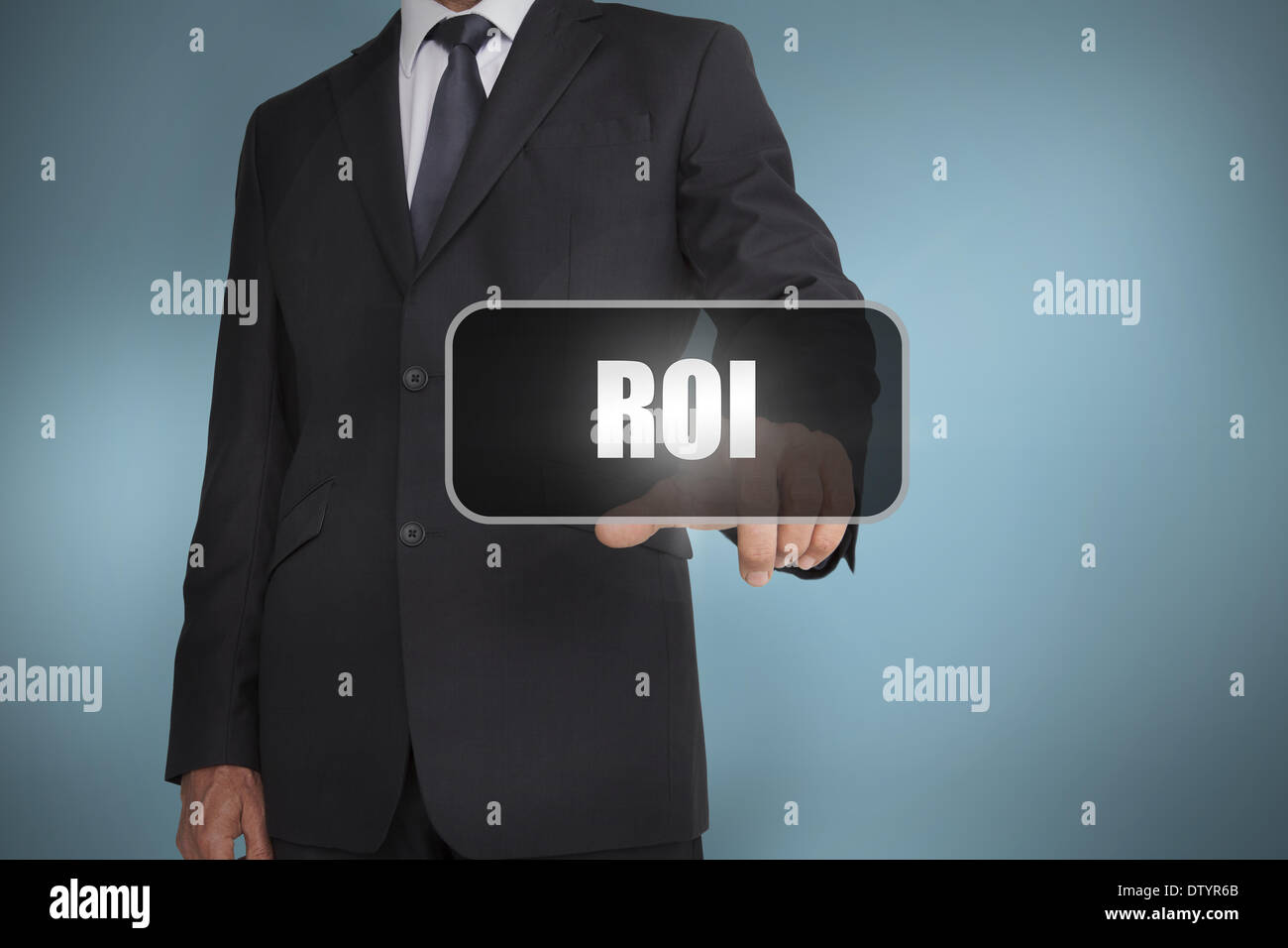 Businessman touching the word roi Stock Photo - Alamy