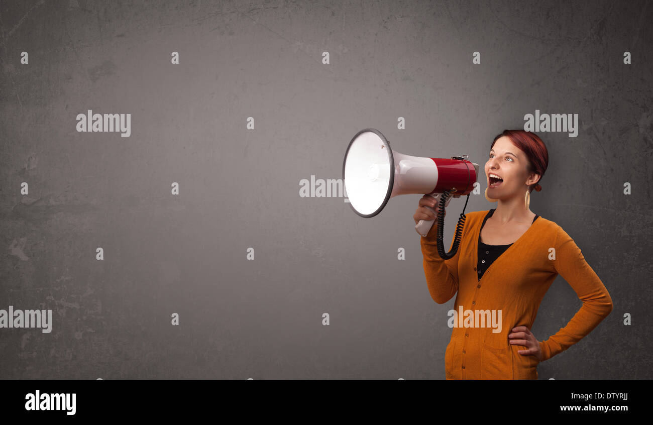 Girl shouting into megaphone on copy space background Stock Photo - Alamy