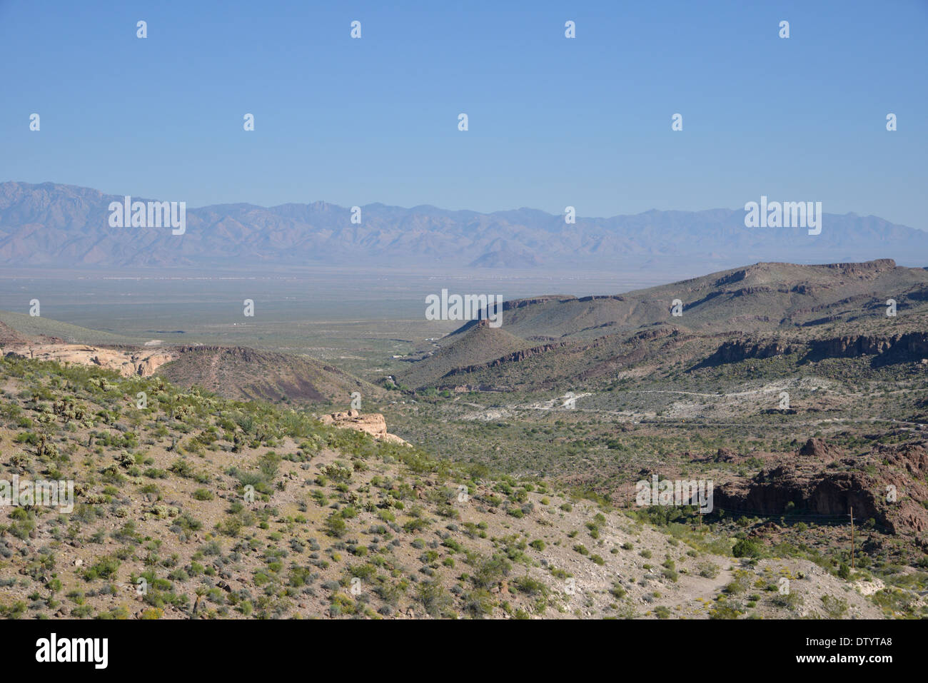 Rocks and scrub land in the foothills around 'the Witch's Teat' rock ...