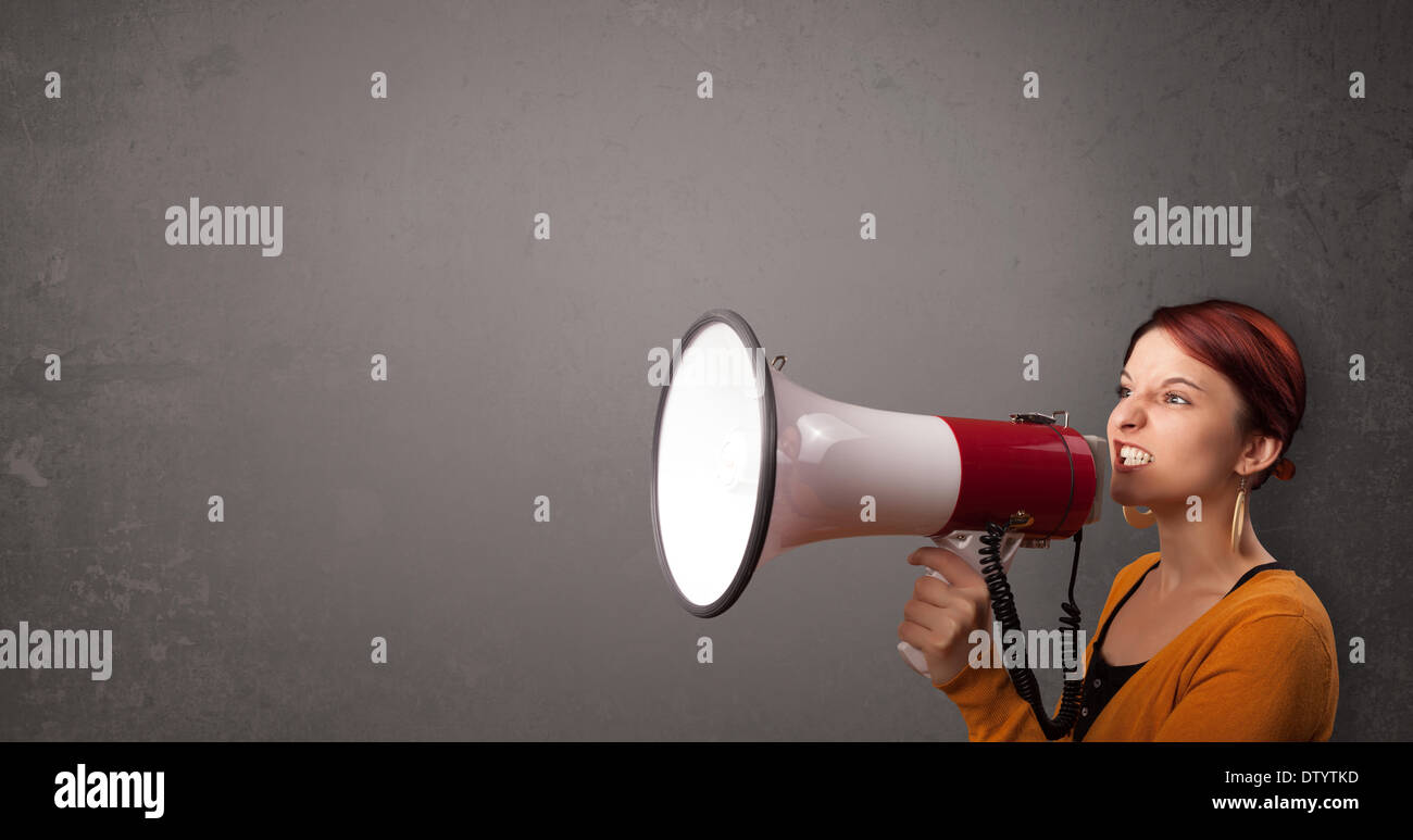 Girl shouting into megaphone on copy space background Stock Photo - Alamy