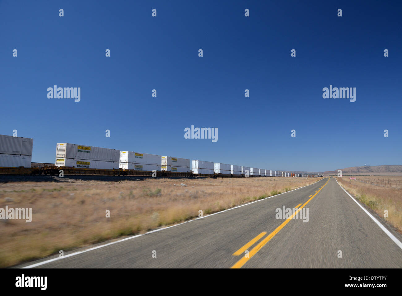 Route 66, Arizona, USA. Long road runs alongside a goods train on the ...