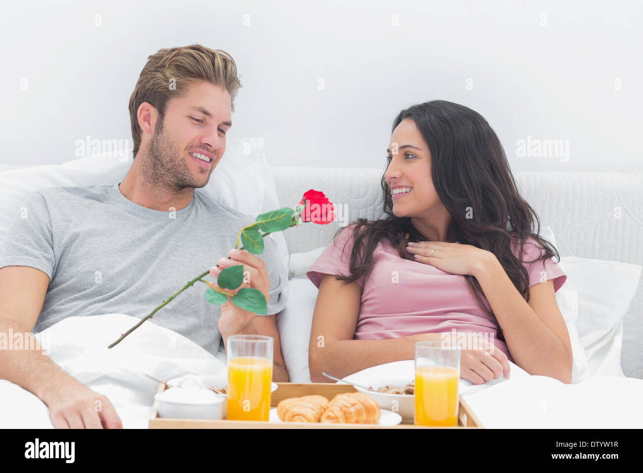 Man offering a rose to his wife Stock Photo - Alamy