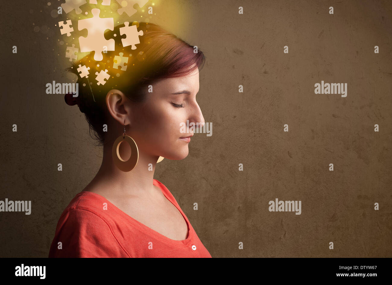 Young person thinking with glowing puzzle mind Stock Photo - Alamy