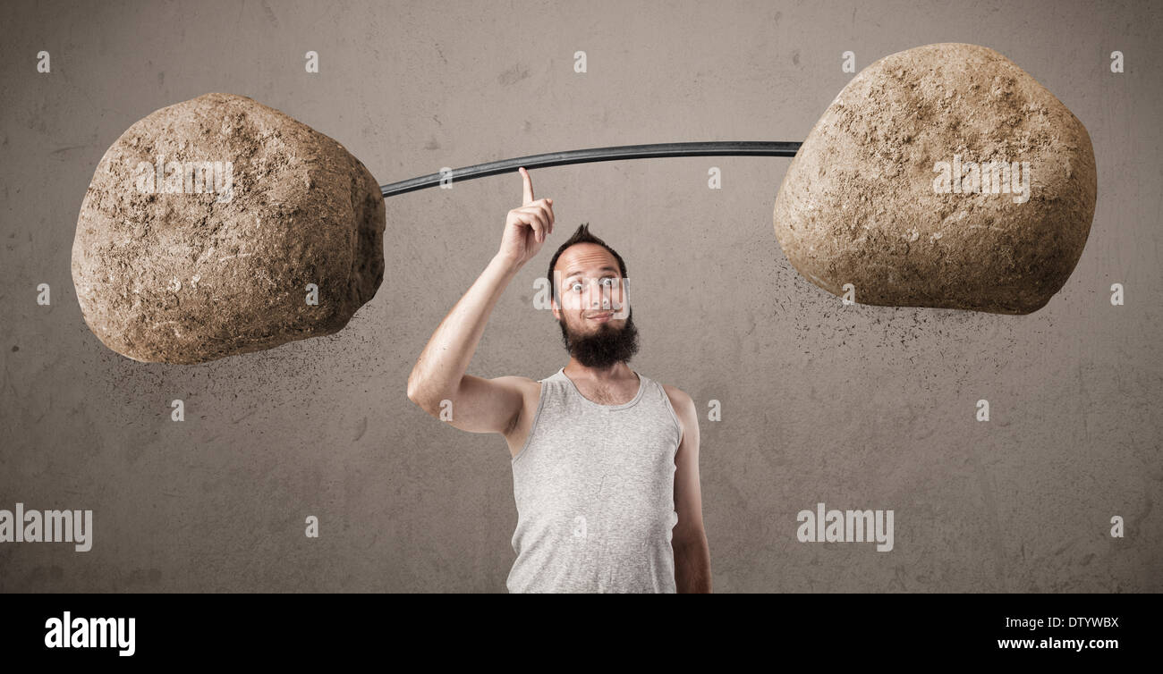 skinny guy lifting large rock stone weights Stock Photo - Alamy