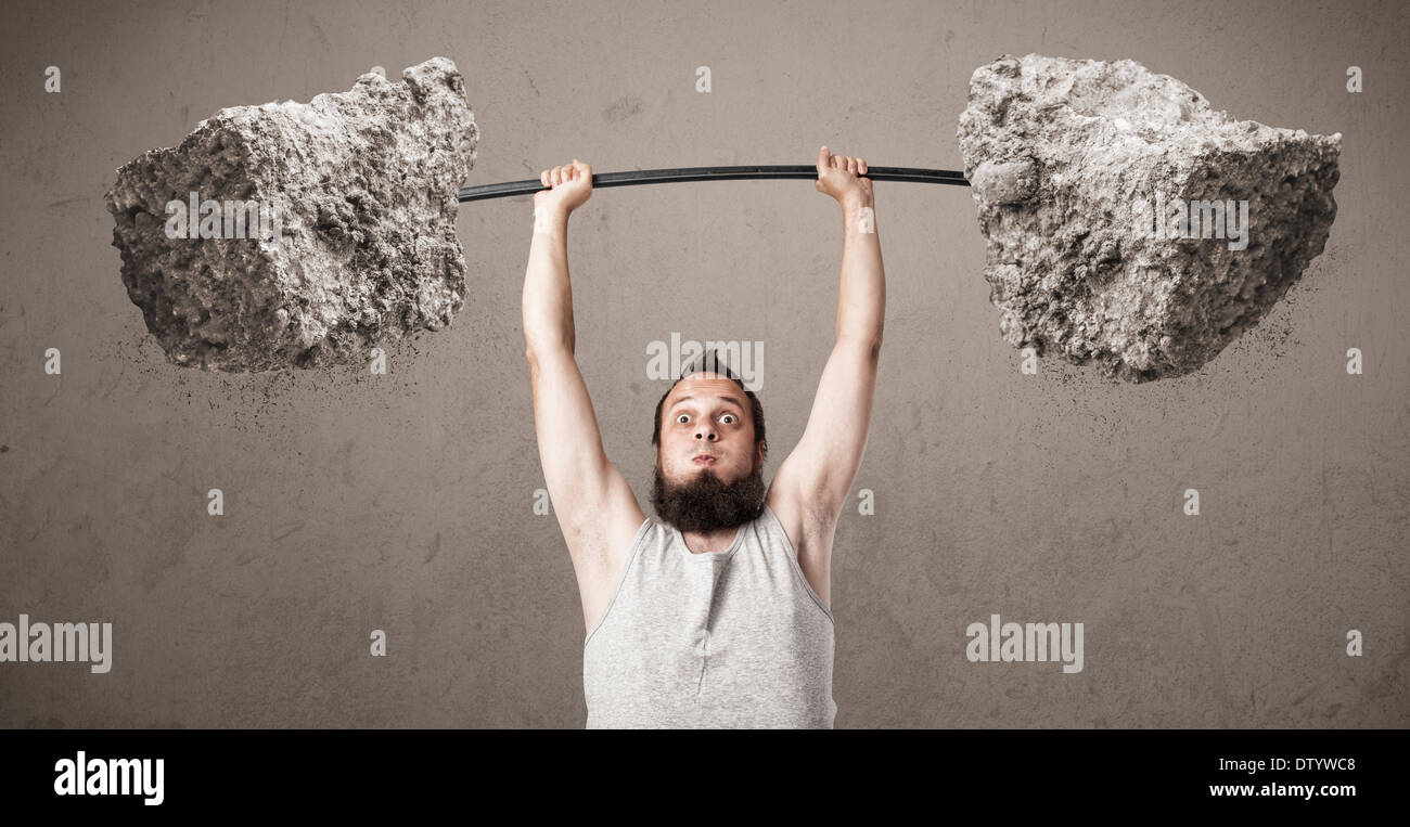 skinny guy lifting large rock stone weights Stock Photo - Alamy