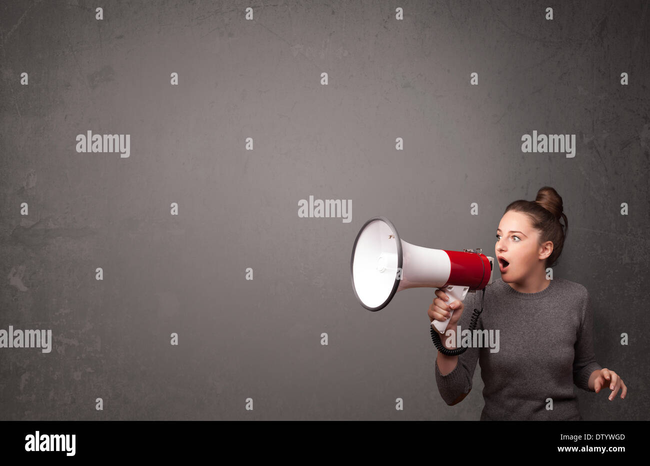 Girl shouting into megaphone on copy space background Stock Photo - Alamy