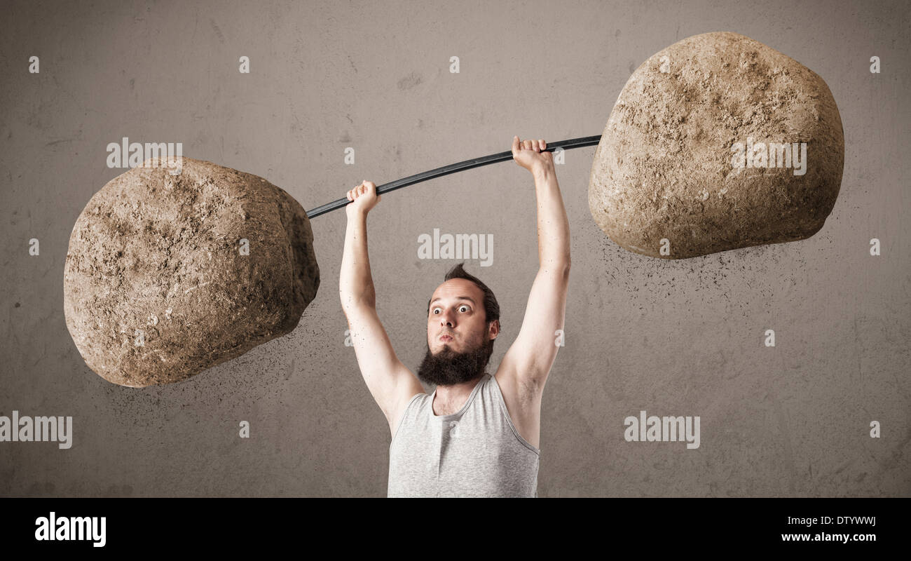 skinny guy lifting large rock stone weights Stock Photo - Alamy