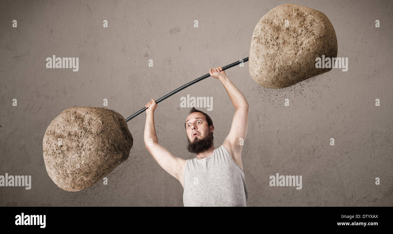 skinny guy lifting large rock stone weights Stock Photo - Alamy