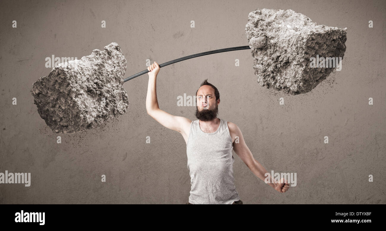 skinny guy lifting large rock stone weights Stock Photo - Alamy