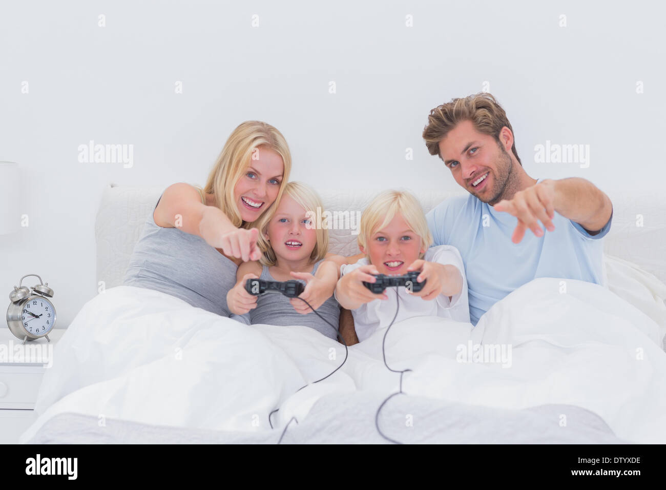 Happy family playing video games Stock Photo - Alamy