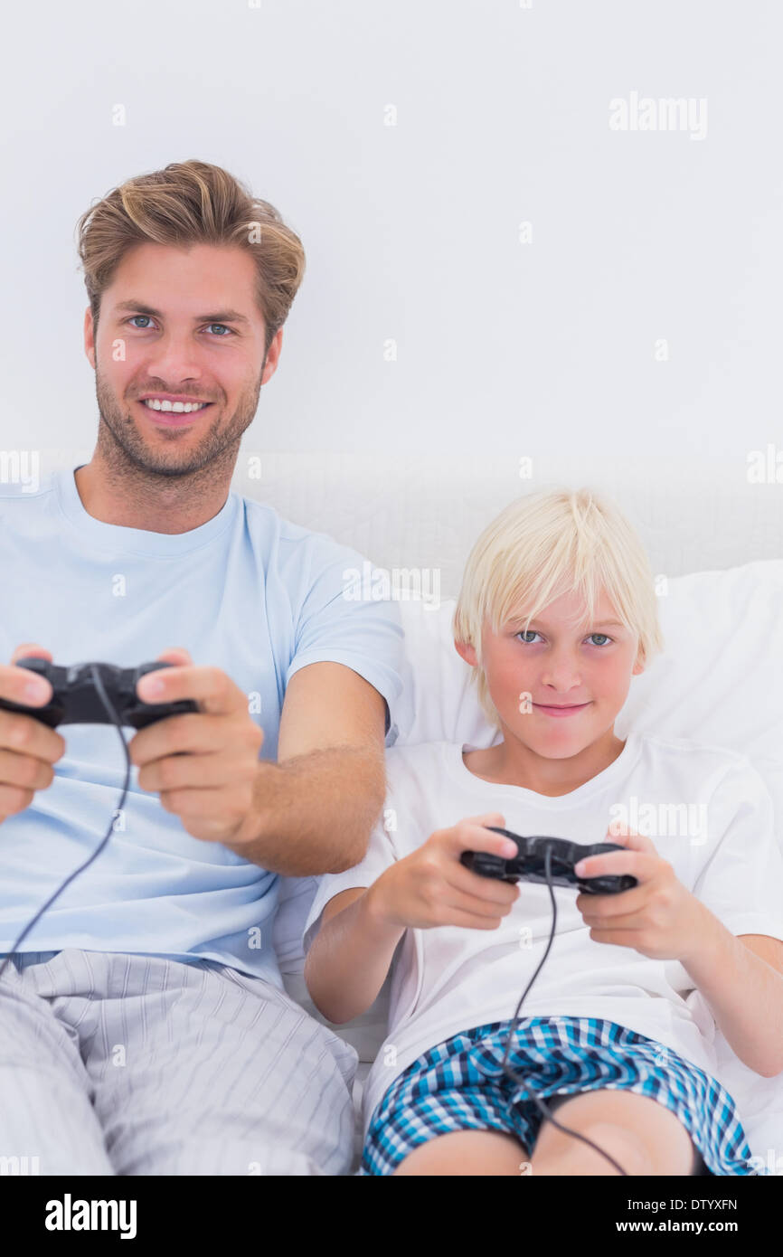 Happy father and son playing video games Stock Photo - Alamy