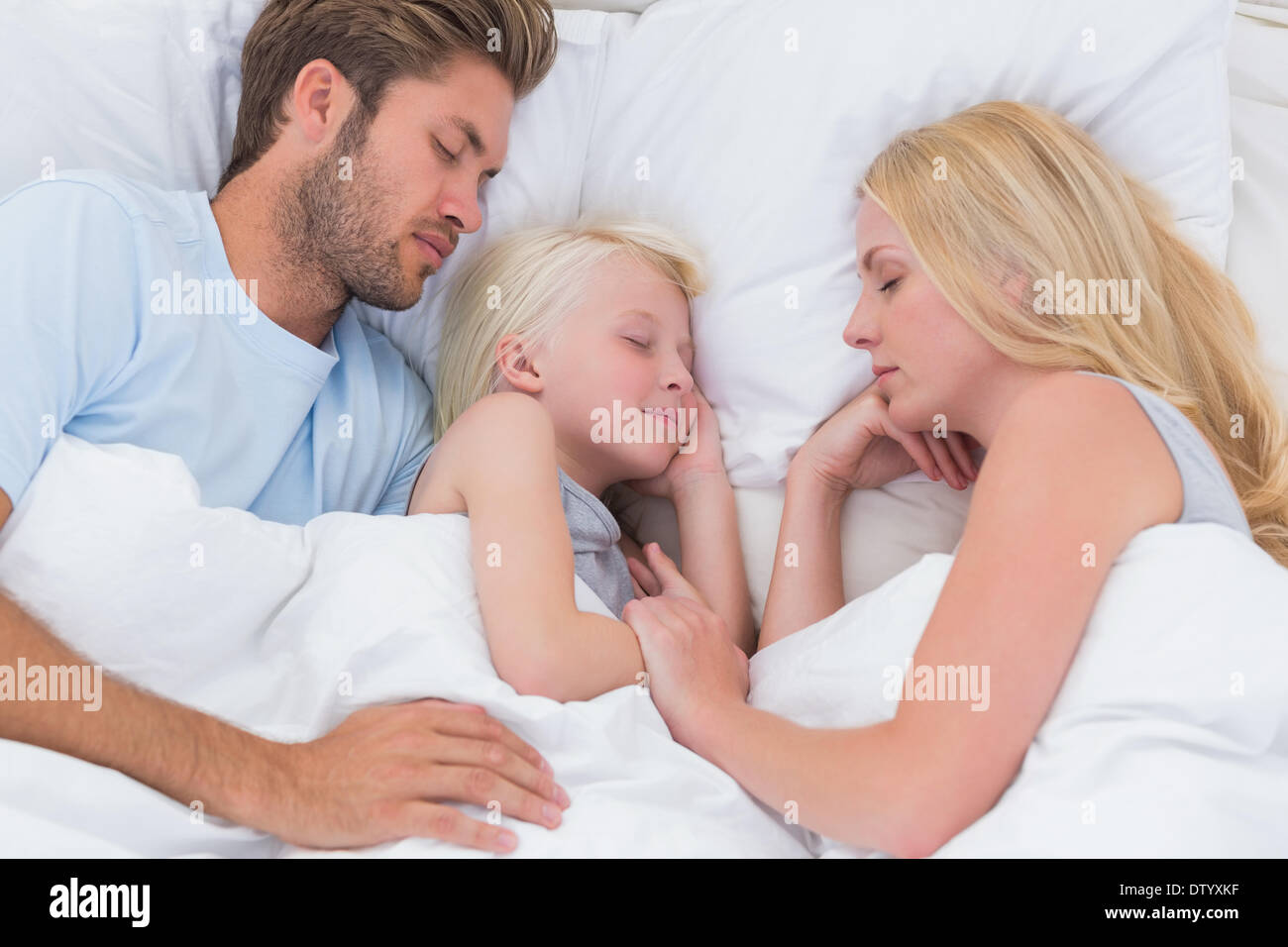 Beautiful family sleeping together Stock Photo - Alamy
