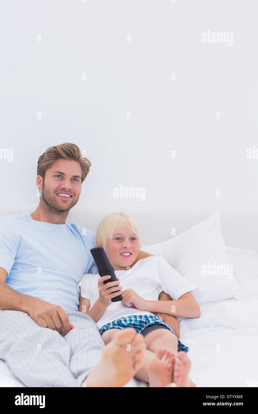 Happy father and son watching TV together Stock Photo - Alamy