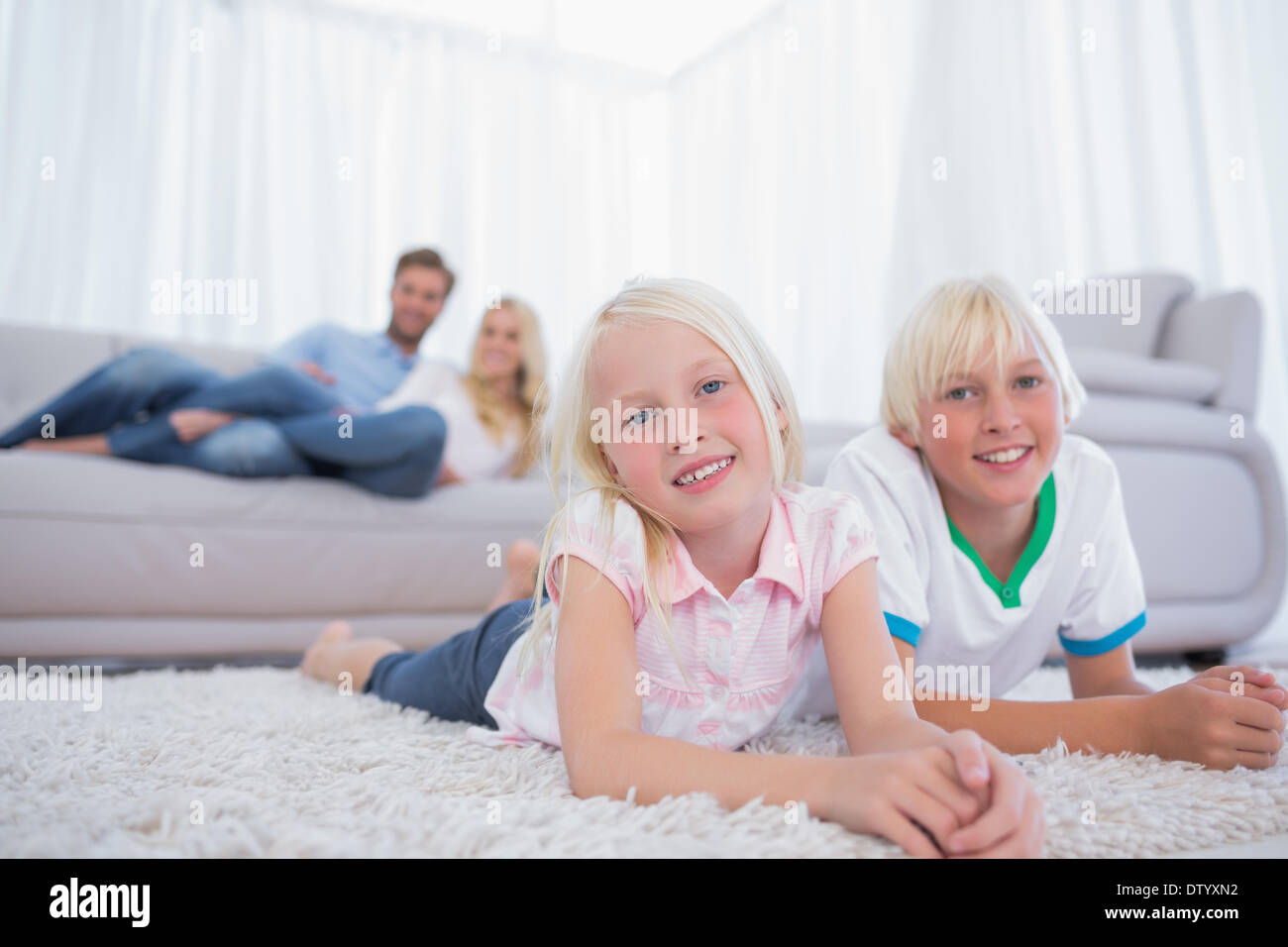 Children lying on the carpet Stock Photo - Alamy