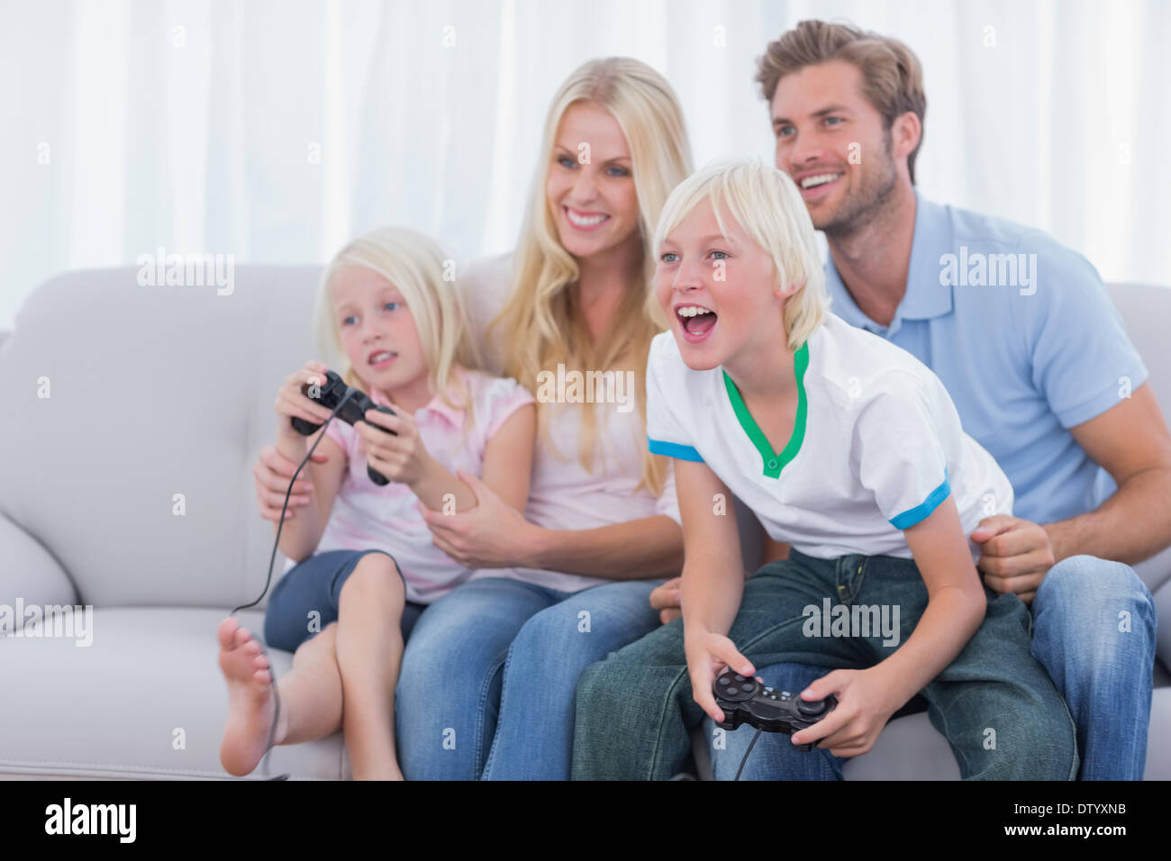 Family playing video games Stock Photo - Alamy