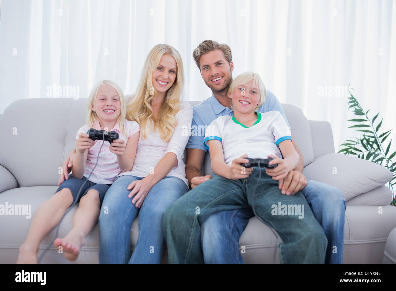 Family playing video games together Stock Photo - Alamy