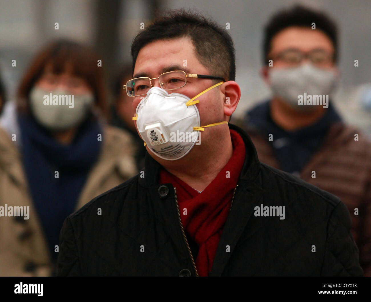 Beijing, CHINA, China. 23rd Feb, 2014. Chinese wear face masks to ...