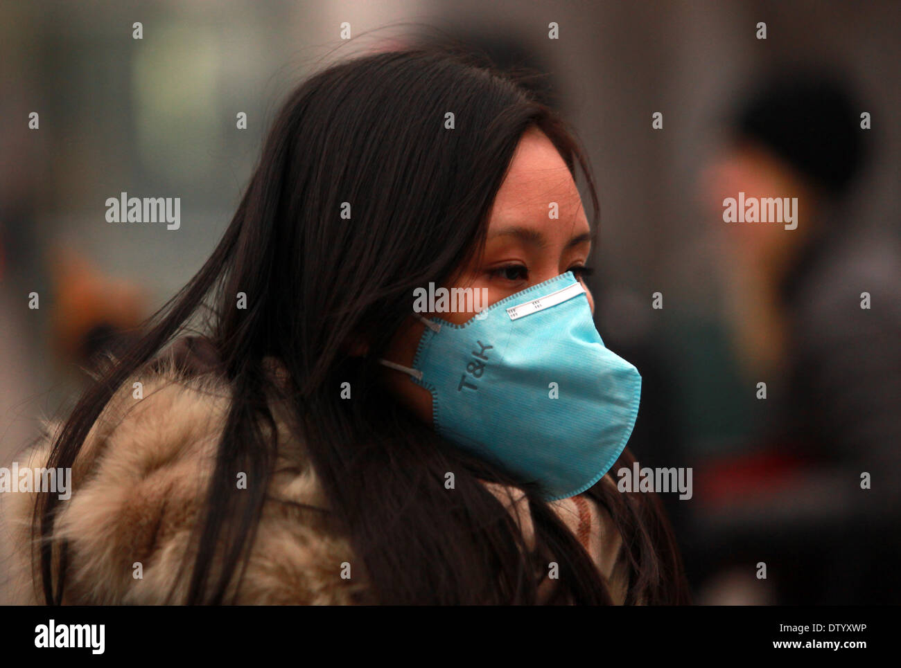 Beijing, CHINA, China. 23rd Feb, 2014. Chinese wear face masks to ...