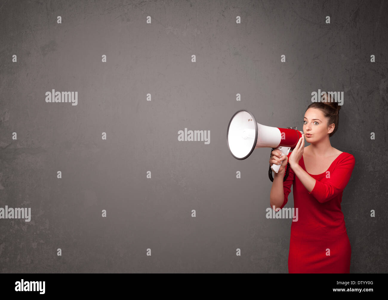 Girl shouting into megaphone on copy space background Stock Photo - Alamy