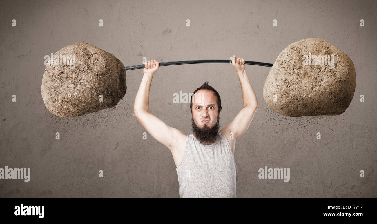 skinny guy lifting large rock stone weights Stock Photo - Alamy