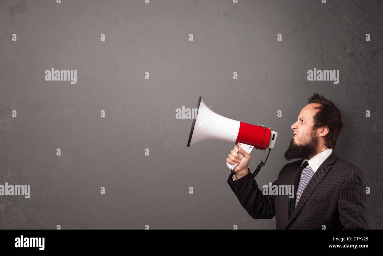 Guy shouting into megaphone on copy space background Stock Photo - Alamy