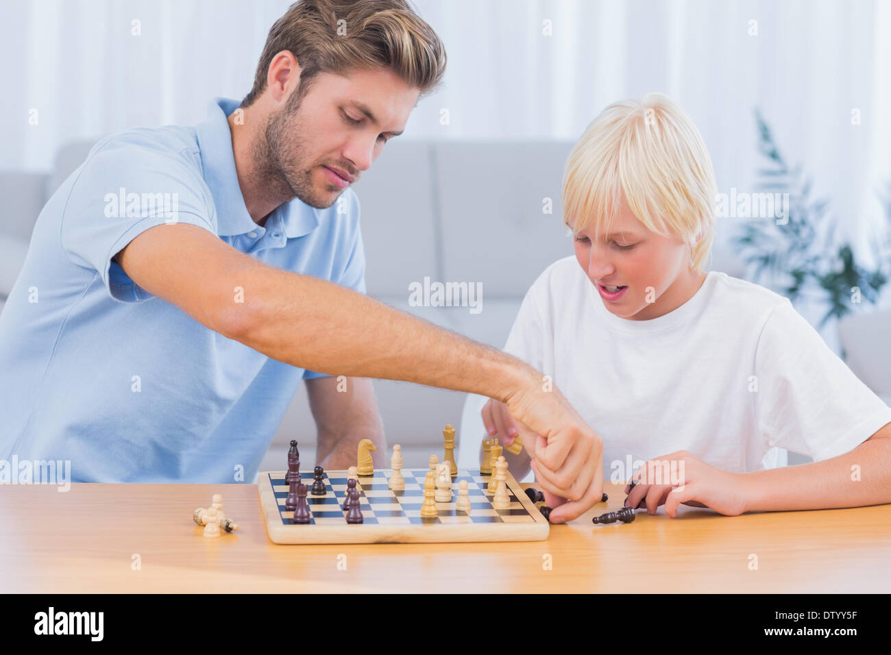 Father and his son playing chess Stock Photo - Alamy