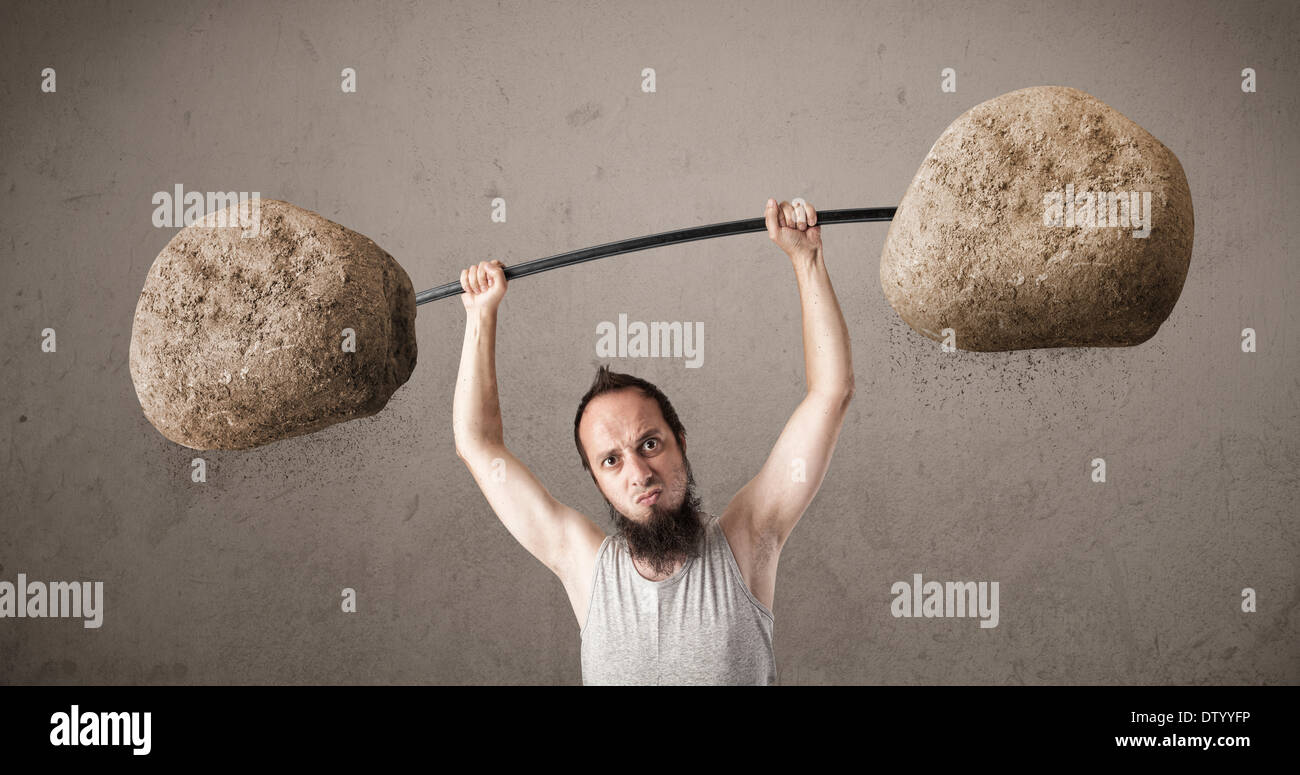 skinny guy lifting large rock stone weights Stock Photo - Alamy