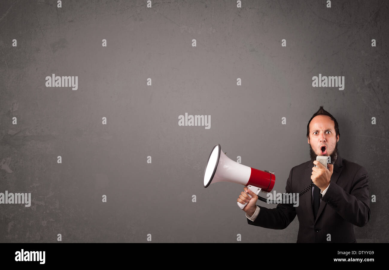 Guy shouting into megaphone on copy space background Stock Photo - Alamy