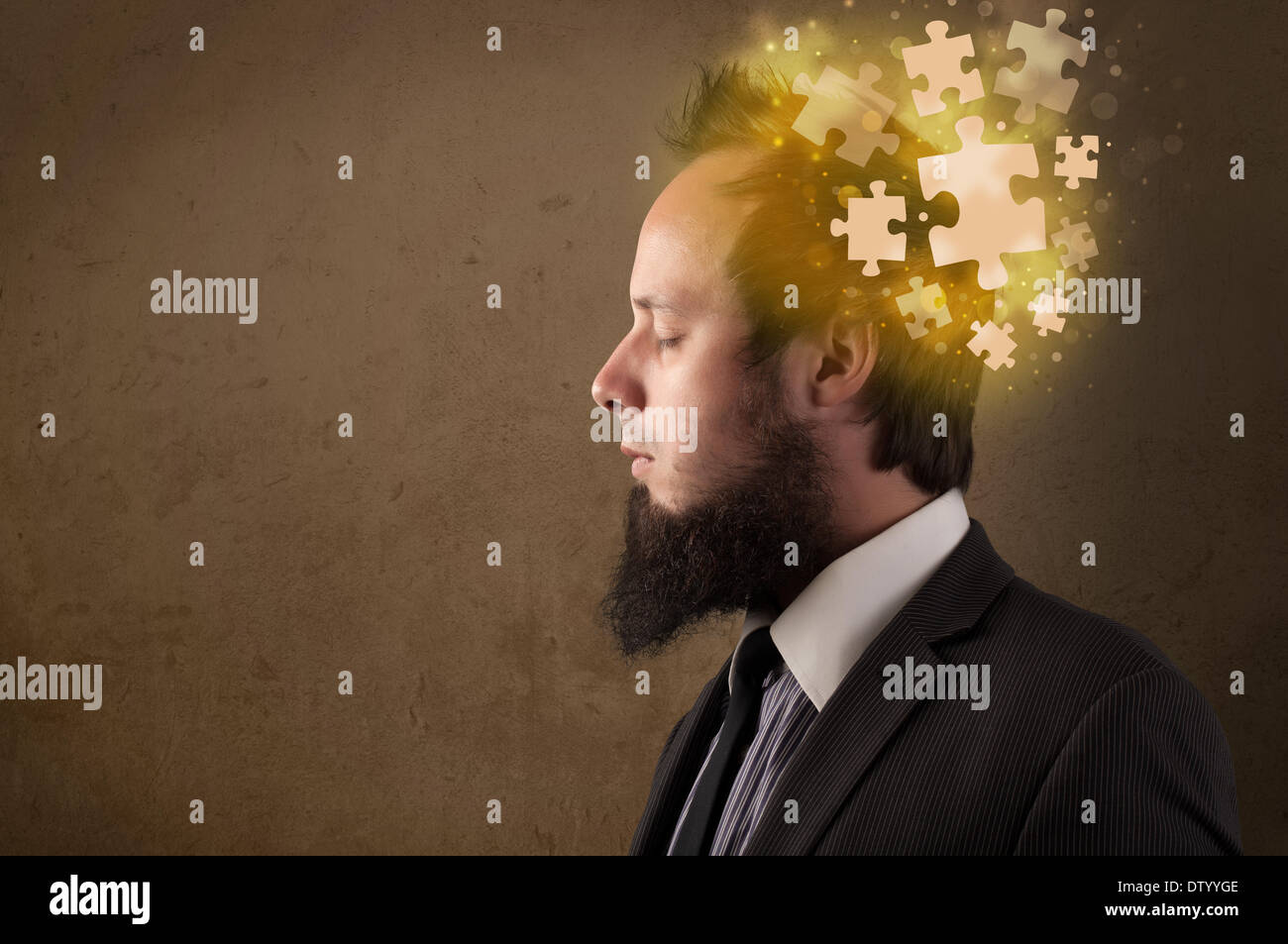 Young person thinking with glowing puzzle mind Stock Photo - Alamy