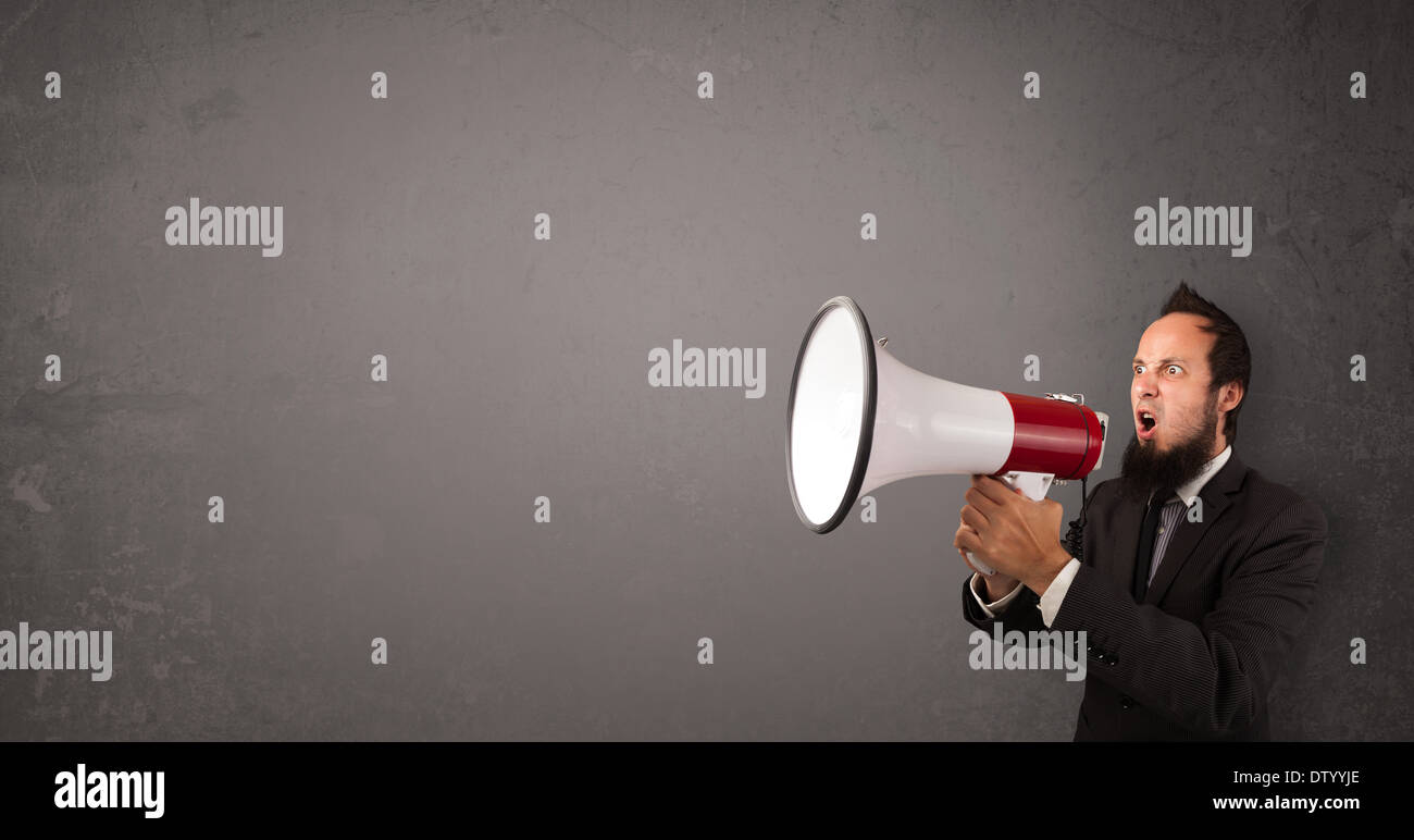 Guy shouting into megaphone on copy space background Stock Photo - Alamy