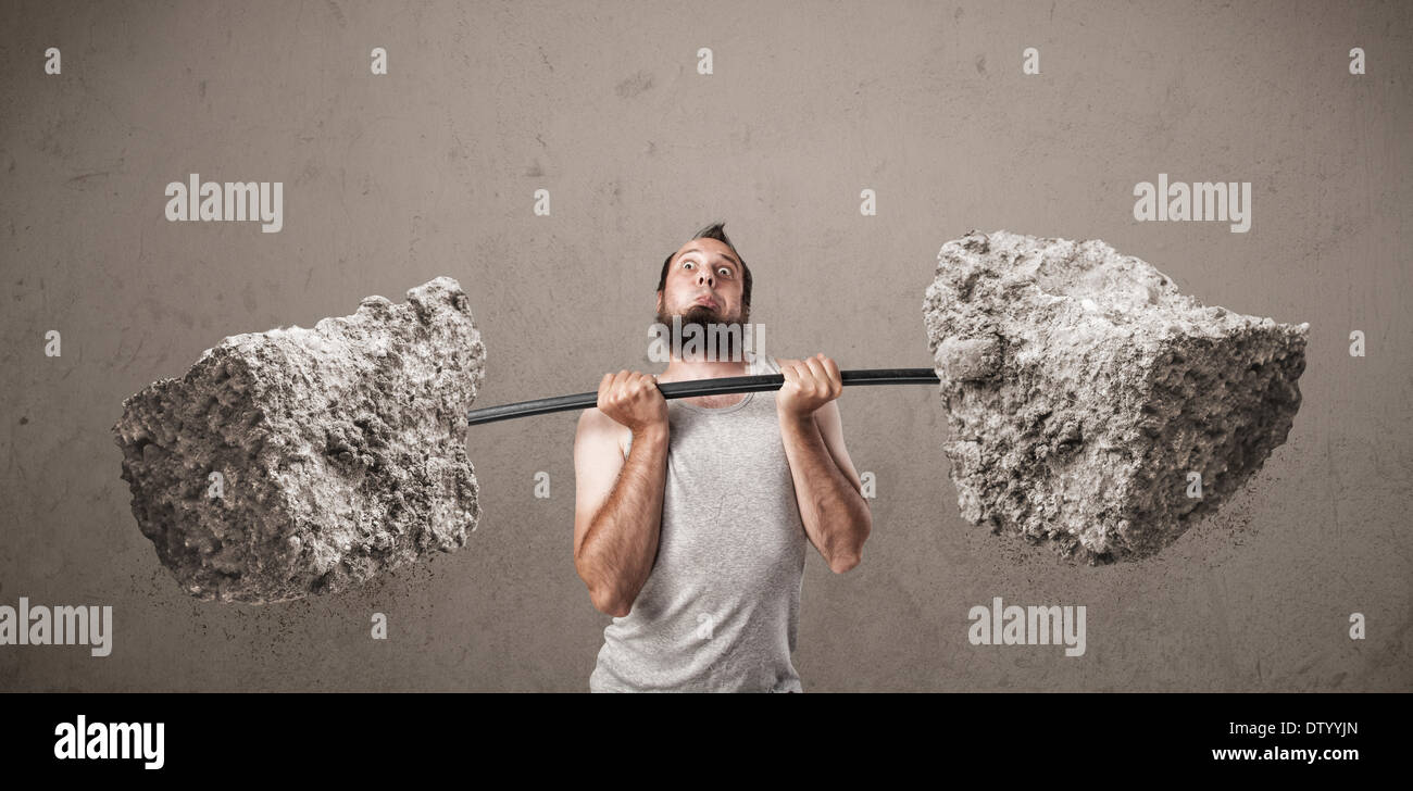 skinny guy lifting large rock stone weights Stock Photo - Alamy