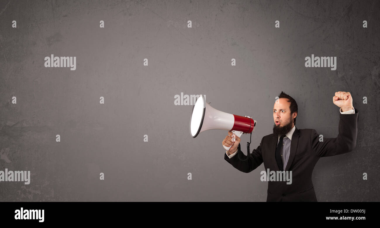 Guy shouting into megaphone on copy space background Stock Photo - Alamy